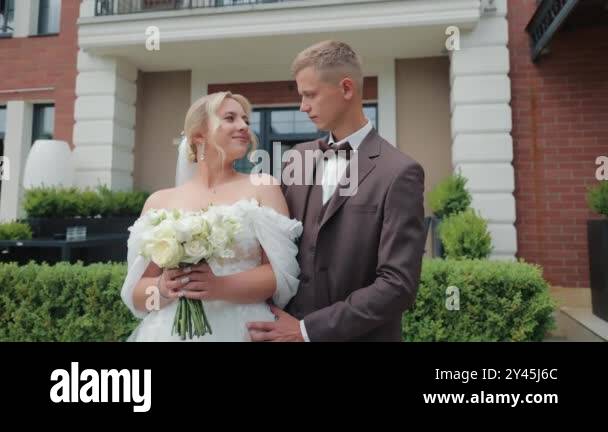 Bride and groom standing together on their wedding day. A joyful bride ...