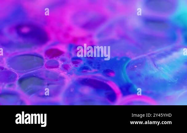 Bubble fluid. Wet foam. Defocused neon pink purple blue color glitter ...