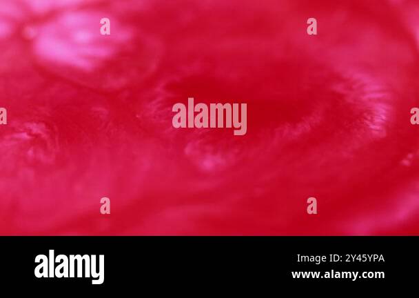 Paint splash. Fluid spill. Defocused bright red pink color emulsion ...