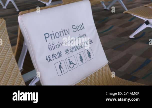 Priority seating area in airport with multilingual signage for ...