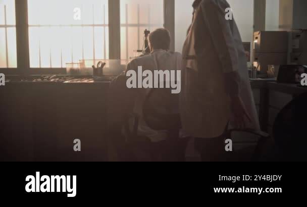 Mature microbiologist conducts fossil analysis using microscope. Bones ...