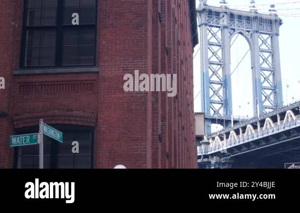 New York City Manhattan Bridge in Dumbo, Brooklyn. Red brick building on Washington street near ...