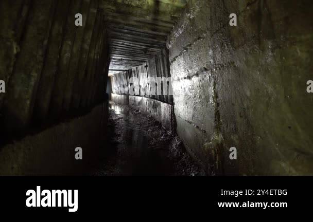 Concrete drainage rainwater collector, inside view. Dark sewer drainage ...