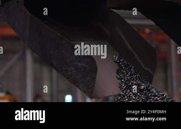 Metal shavings running trough a collector into a recycle bin Stock ...