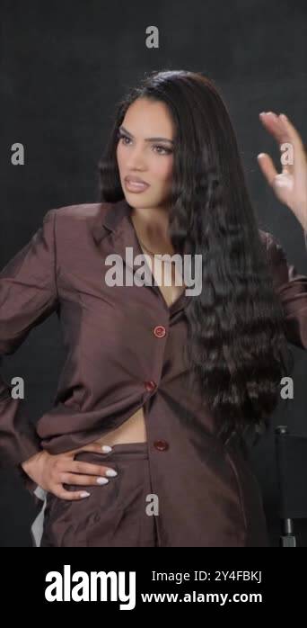 A confident woman in a stylish brown suit showcases various looks of ...