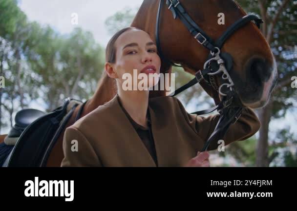 Gorgeous woman caressing horse at farm portrait. Happy cowgirl bonding ...