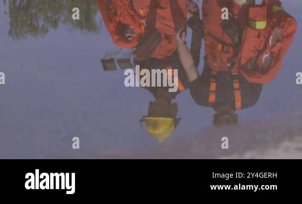 A group of prepared firefighters stands ready for hazardous tasks ...