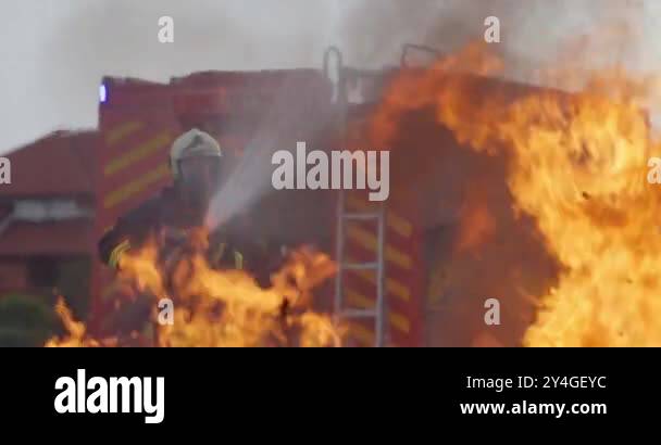 Firefighters fight the fire flame to control fire not to spreading out ...