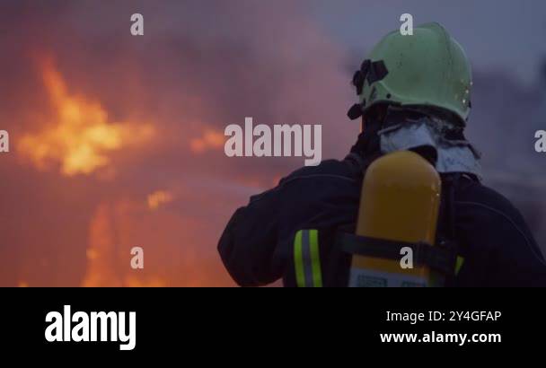 Firefighters fight the fire flame to control fire not to spreading out ...