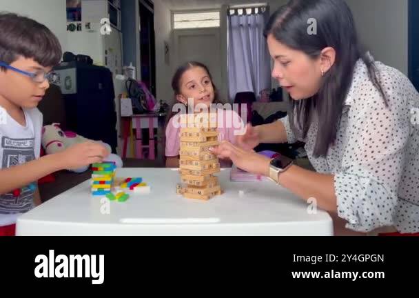 Video of beautiful Latino children playing with blocks on a white table. International Children ...