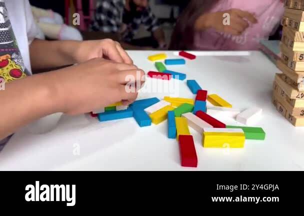 Video of beautiful Latino children playing with blocks on a white table. International Children ...