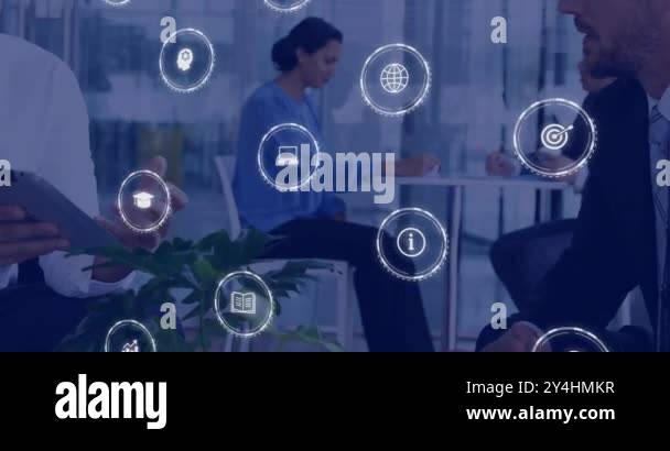 Business icons animation over people having meeting in modern office ...