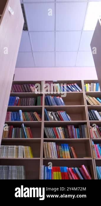 Library books stacked on shelves. Rows of bookcases with books in the ...