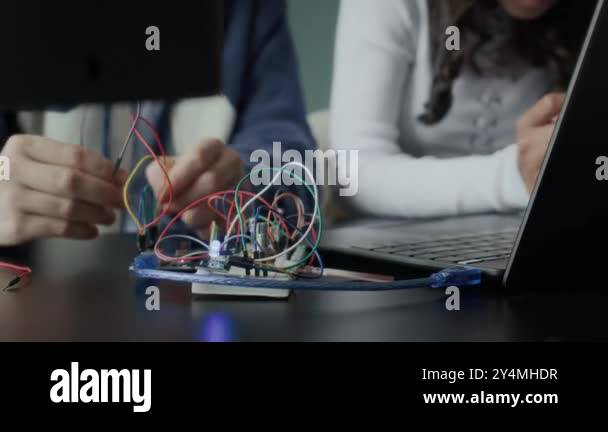Tilt up shot of two multiethnic gen z female classmates assembling ...