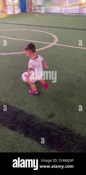 Aceh, Indonesia - August 11, 2024: The kid play ball in field. A kid ...