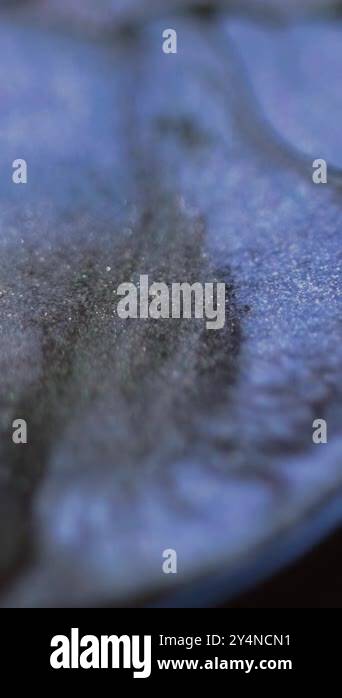 Vertical video. Ink drop. Glitter fluid splash. Blur blue black color ...