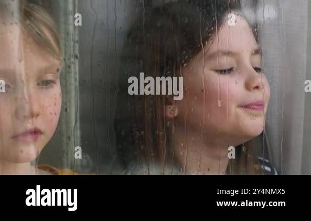 Two little girls children preteen crisis looking window sad sorrow ...
