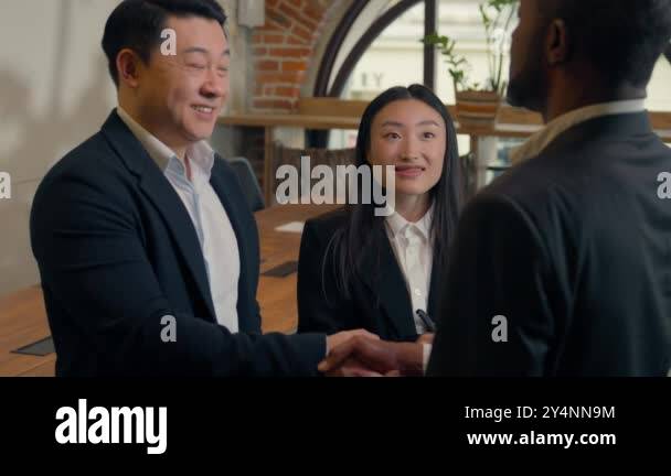 Three business multiracial people multiethnic colleagues diversity coworkers in office meeting ...