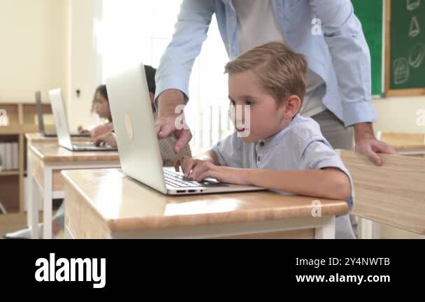 Caucasian teacher helping energetic boy coding engineering prompt while diverse student using ...