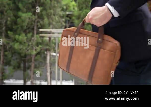 Close up of suitcase was held by profession businessman while project ...