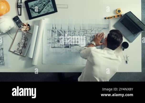Top view of smart civil engineer drawing and measuring blueprint by ...