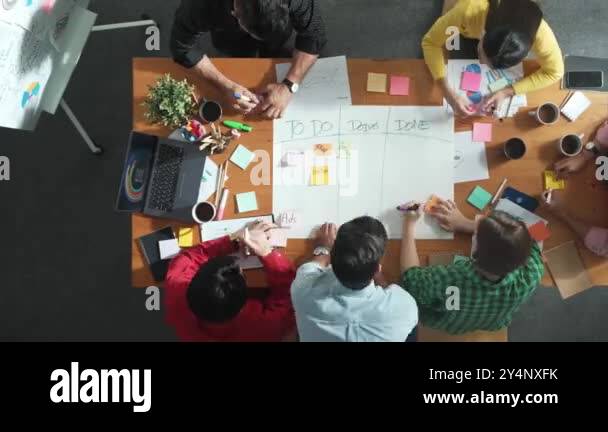 Top down aerial view of business team making scrum task board at ...