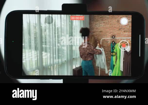 Rear view behide smartphone screen recording woman influencer shoot ...