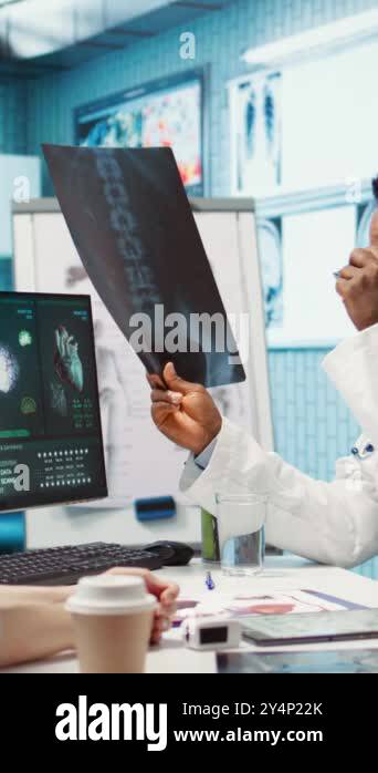 Vertical Video Medic expert showing the x ray imaging test results to ...