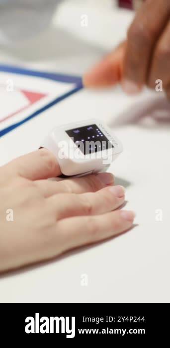 Vertical Video Physician using an oximeter on patient to measure oxygen ...