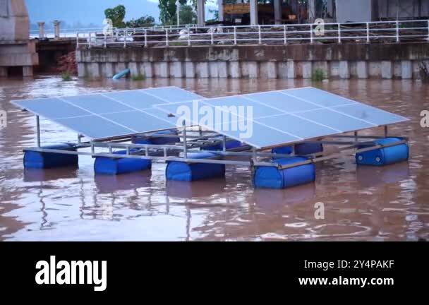 Industrial pond with floating photovoltaic solar panels for producing ...