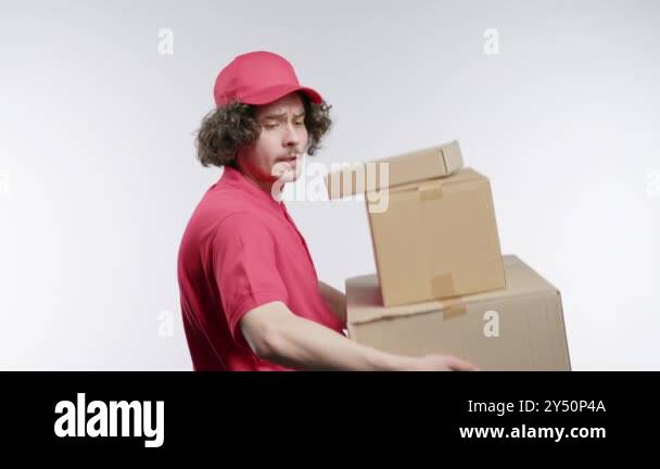 Postal courier man carrying heavy parcel box, overall load. Postman ...