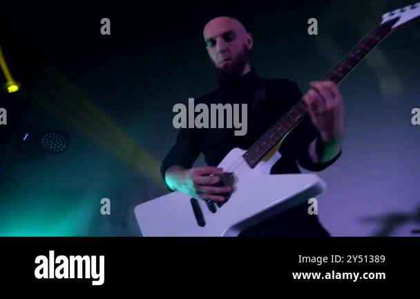 Rock guitarist plays cool guitar at a rock concert. The guy plays ...