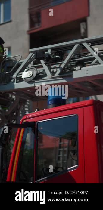 fire truck with extended elevated ladder reaches up to residential ...