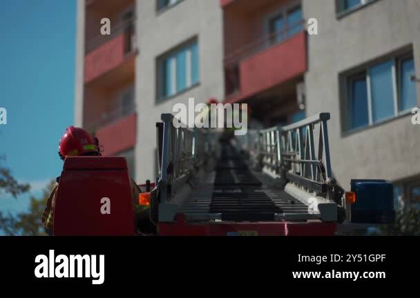fire truck with extended elevated ladder reaches up to residential ...