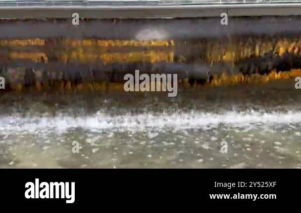 4K footage of water flow and stream down from a water fontain pond ...