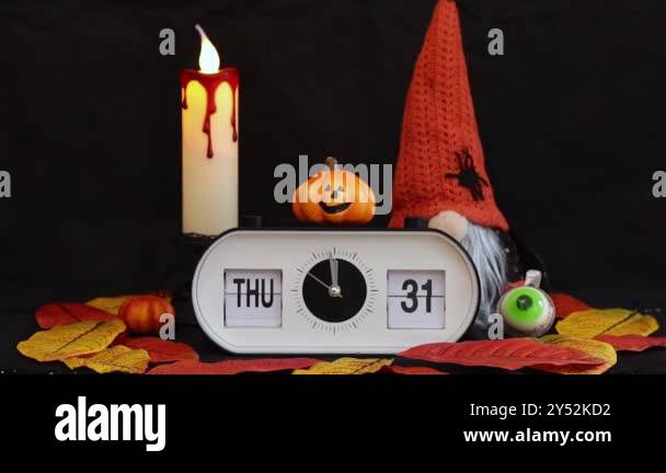 Clock with time, date and day: Thursday 31 with a Halloween gnome toy ...