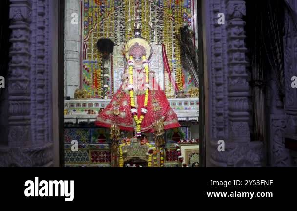 hindu goddess idol decorated with flowers at holy temple at indoor ...
