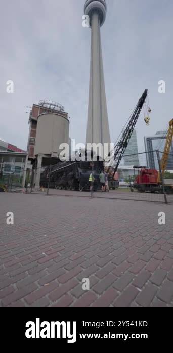Black steam train underneath CN Tower, Toronto, rec709 4k vertical ...