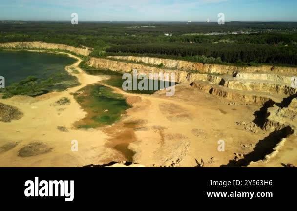 Open-Pit Dolomite Quarry with Lake, Beach, and Forest Background The ...