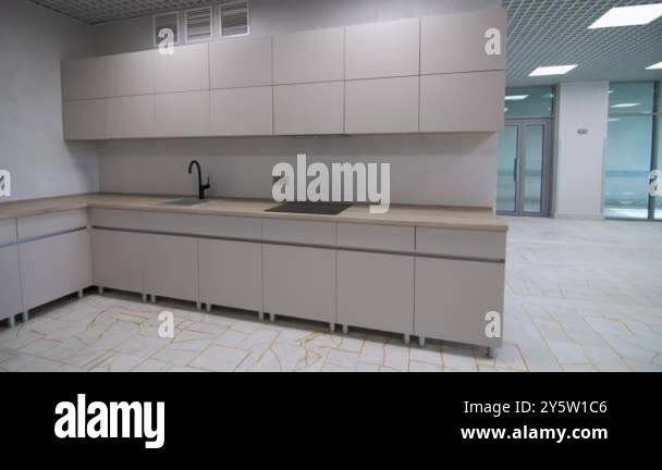 Minimalist kitchen unit with cabinets and sink faucet in office ...