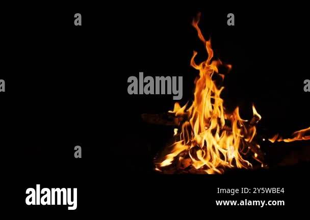 Bonfire burning on black background with space for text. The flames are ...