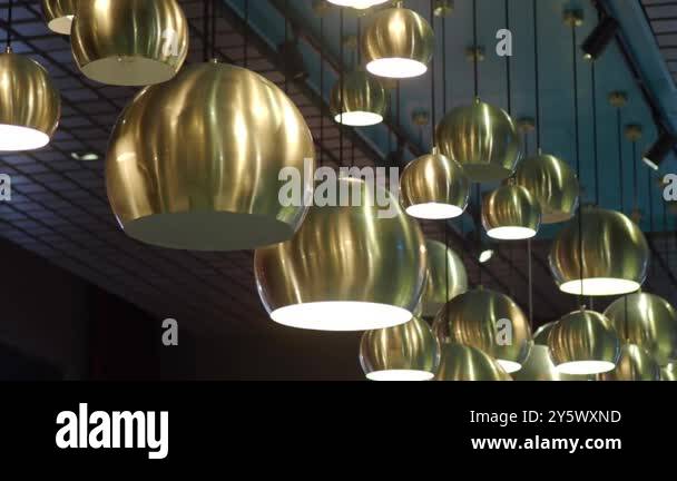 Stylish and elegant gold pendant lights elegantly illuminate a ...