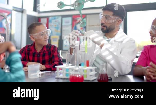 Scientist demonstrating experiment to children over molecular structure ...
