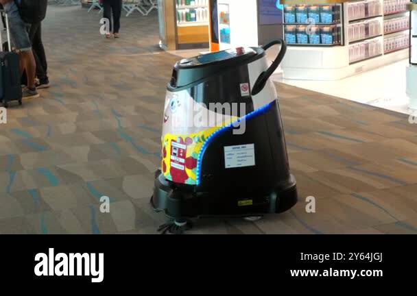 Cleaning robot in modern airport terminal, illustrating advancements in ...