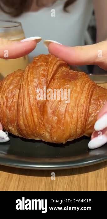 beautiful woman in cafe serving cappuccino with croissant.girl breaking ...