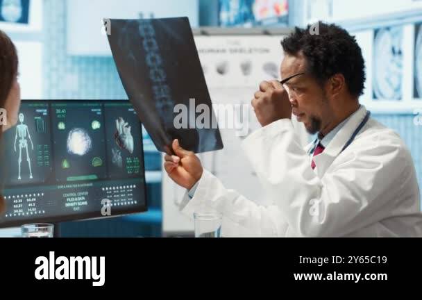 Medic expert showing the x ray imaging test results to patient at check ...