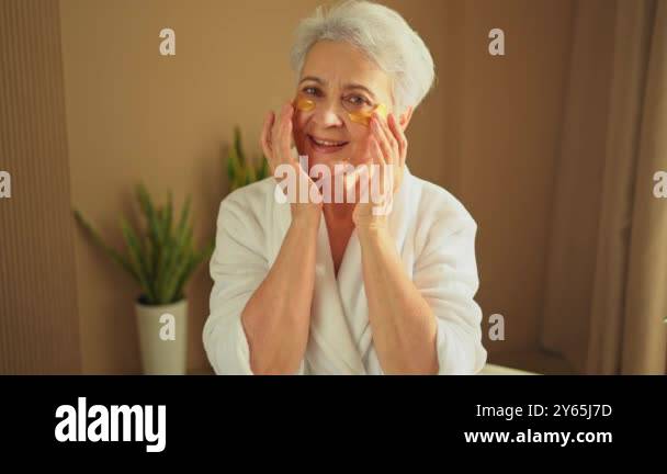 Eye patch beauty aging treatment. Mature adult old woman with under eye ...