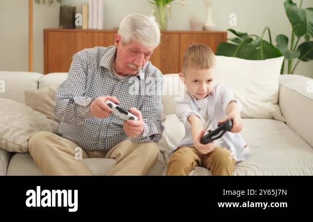 Happy family. Old senior man grandfather boy grandson playing video ...