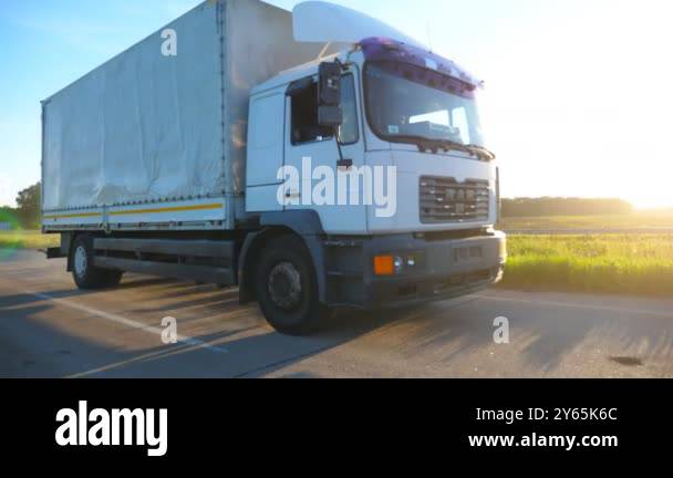 Truck with cargo trailer driving on highway and transporting goods ...