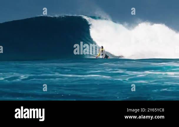 Surfing with speed warp effect. Experienced surfer rides the ocean wave ...